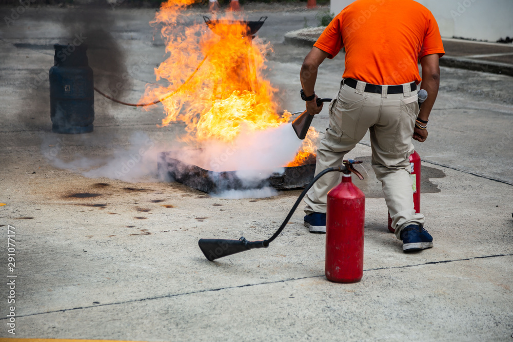 Firemen using extinguisher and water for fight fire during firefight ...