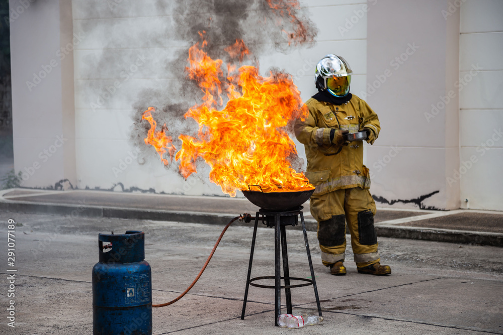 Firemen using extinguisher and water for fight fire during firefight ...