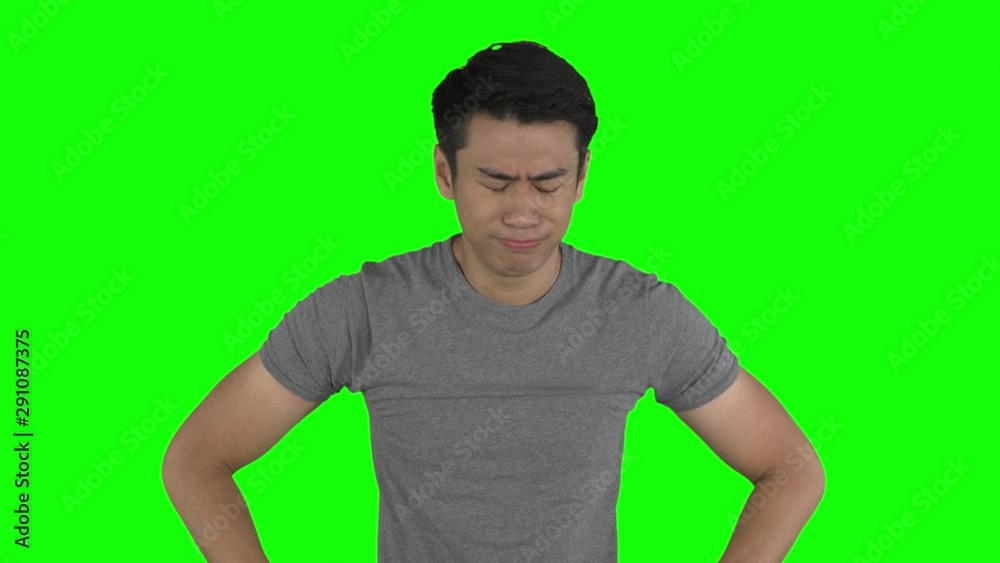 Exhausted handsome man showing a crying gesture in the studio. Shot in ...