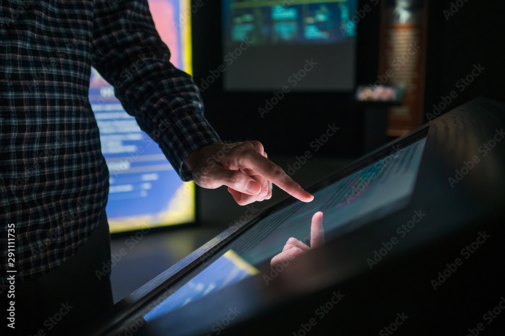 Man hand using interactive touchscreen display of electronic multimedia ...