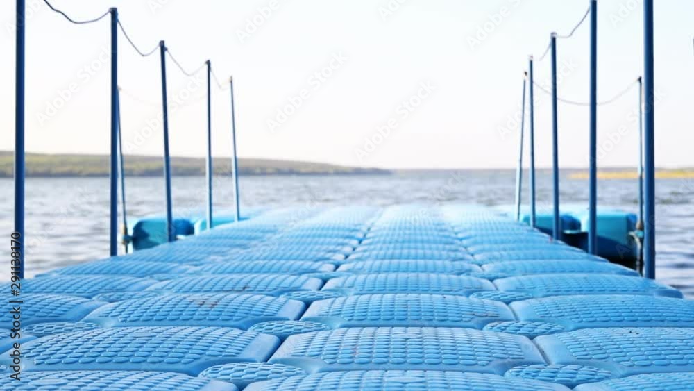 Vídeo do Stock: Blue floating plastic pontoon pier with rope railings ...