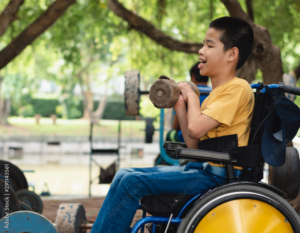 Disabled child on wheelchair is playing, learning and exercise in the ...