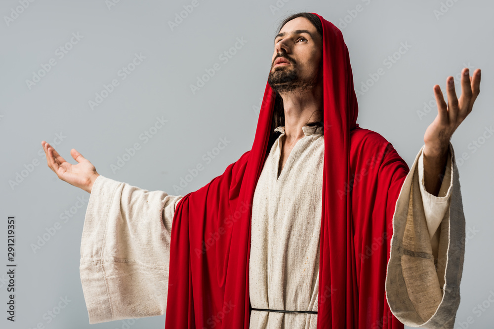 bearded man in red hood praying with outstretched hands isolated on ...