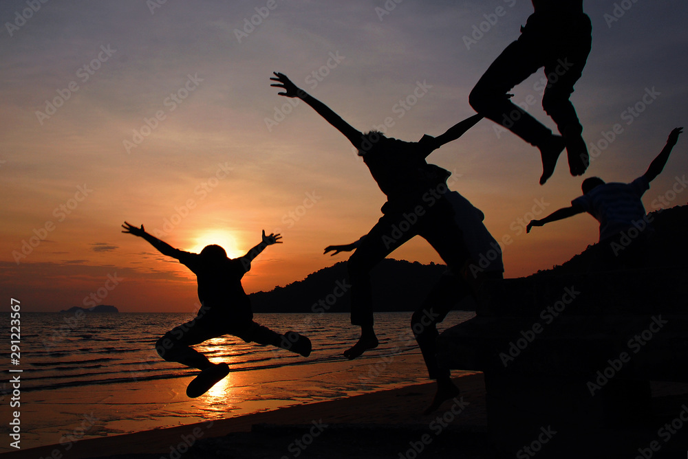 Seen here are a group of teenagers having fun jumping down from a ...