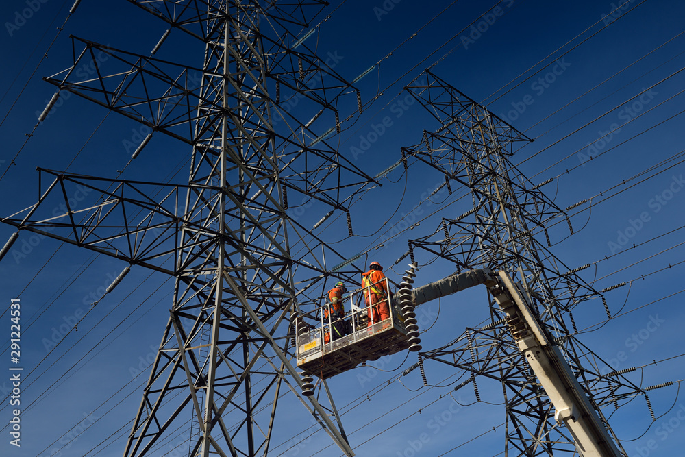 Hydro linemen on boom lift removing old suspension insulators on high ...