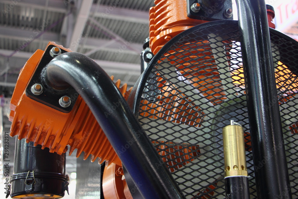 Powerful orange 2 cylinder air compressor heads with pipes and ...