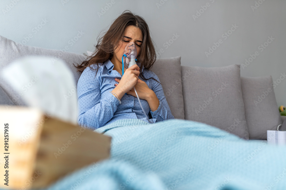 Inhaler helps a lot. Woman with flu or cold symptoms making inhalation ...