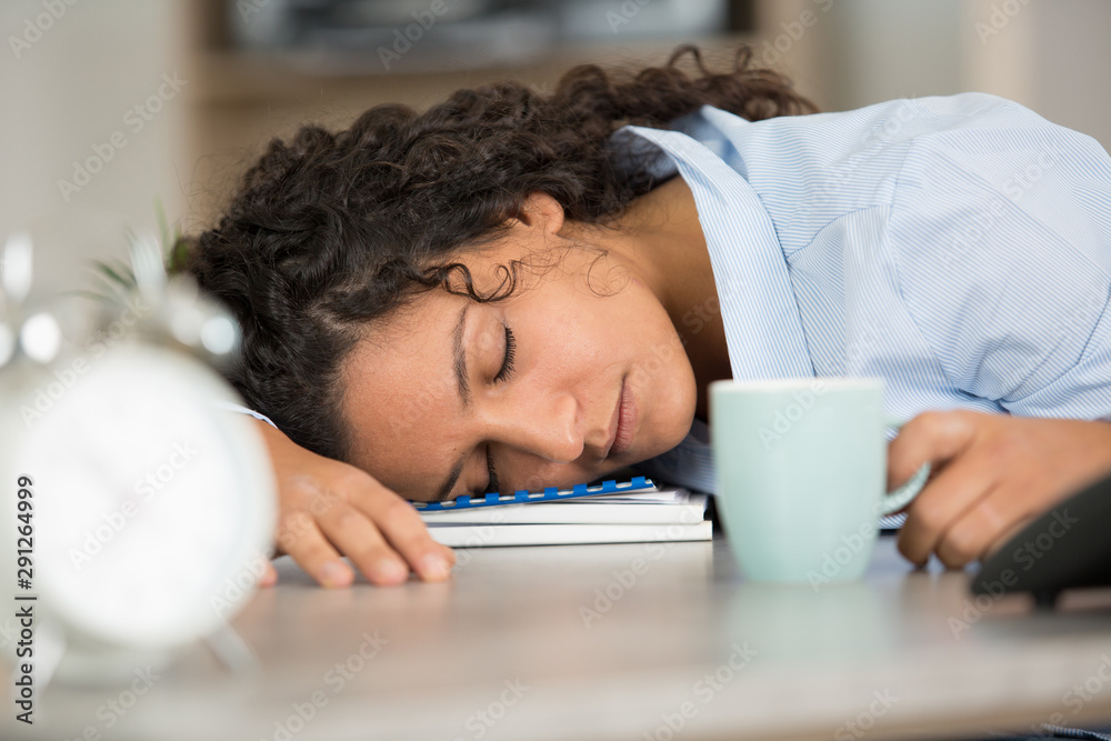 beautiful young woman sleeping on a desk at work Stock Photo | Adobe Stock