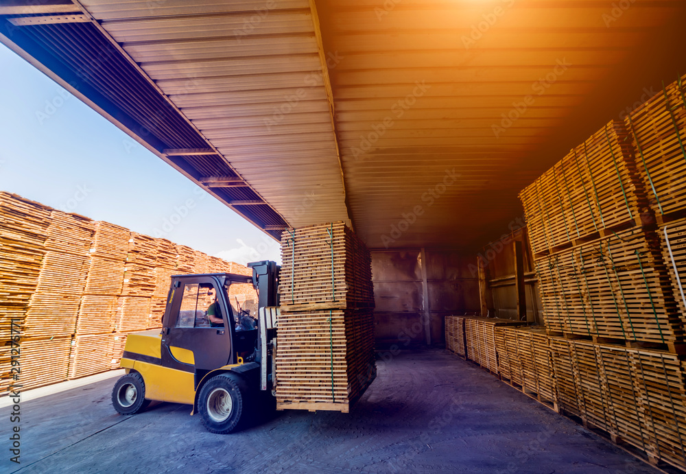 Forklift loader load lumber into a dry kiln. Wood drying in containers ...