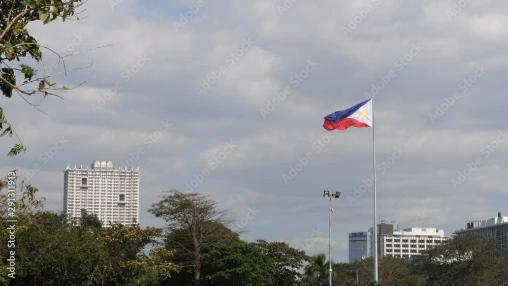 Filipino flag in front of Manila skyline Stock ビデオ | Adobe Stock