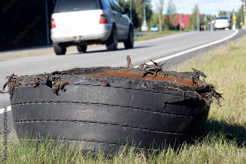 Exploded tire of semi truck on highway roadside. Stock Photo | Adobe Stock