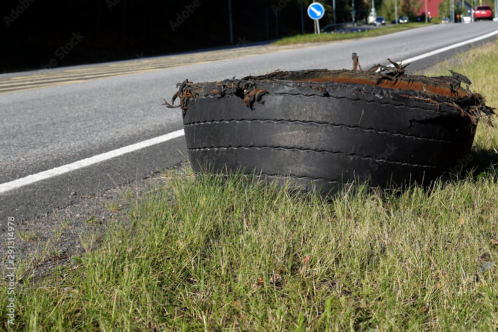 Blowout. Exploded tire of semi truck on highway roadside. Stock Photo ...