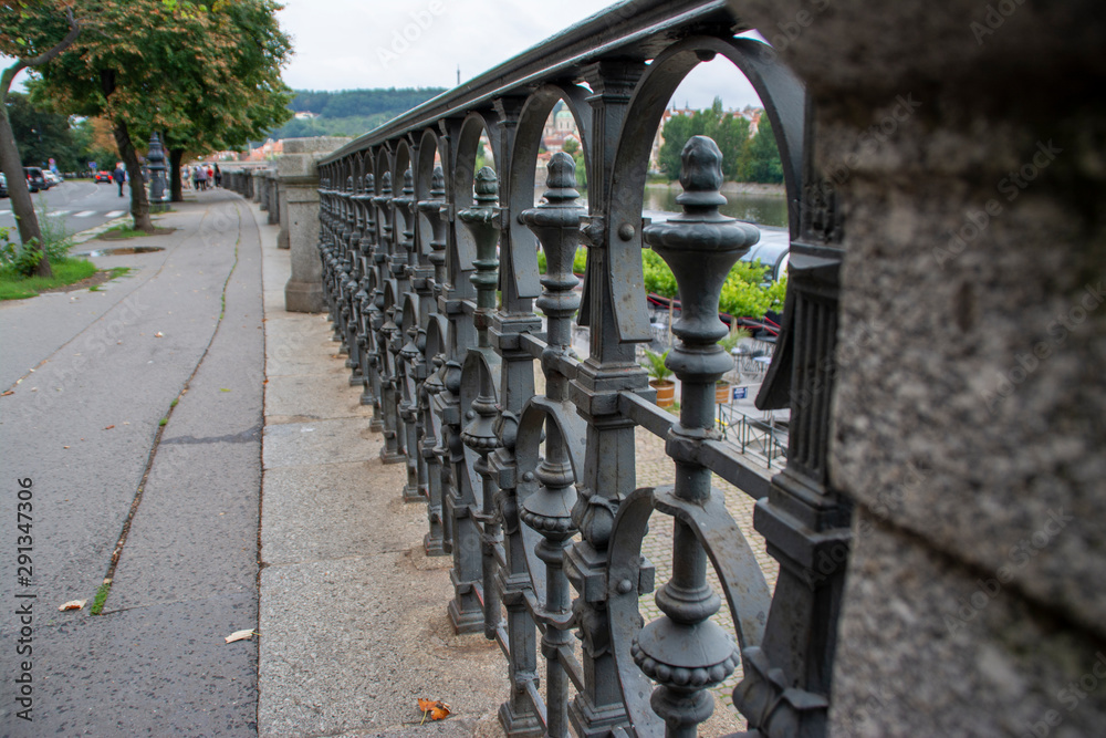 Openwork metal bars on the fence near the promenade for walks in the ...