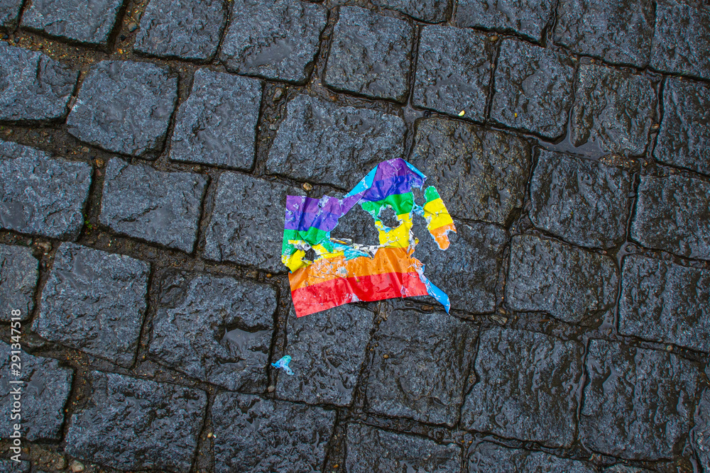 Trampled along the pavement symbol of the LGBT movement rainbow flag ...
