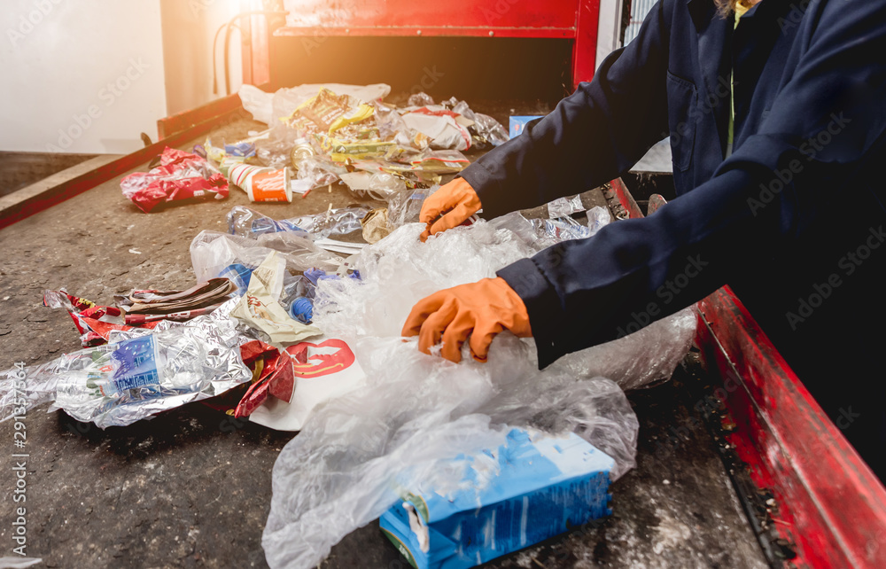At modern recycling plant. Separate garbage collection. Workers sorting ...