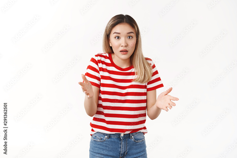 Confused puzzled shocked silly blond asian female friend raise hands ...