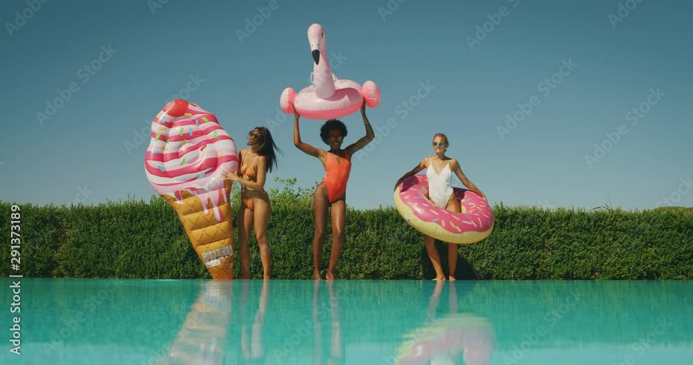 Slow motion of young multi-ethnic girlfriends in bikinis are having fun to enjoy their summer ...