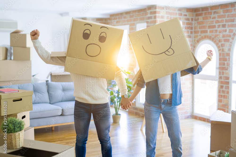 Funny couple wearing cardboard boxes with fun crazy emoji faces over ...