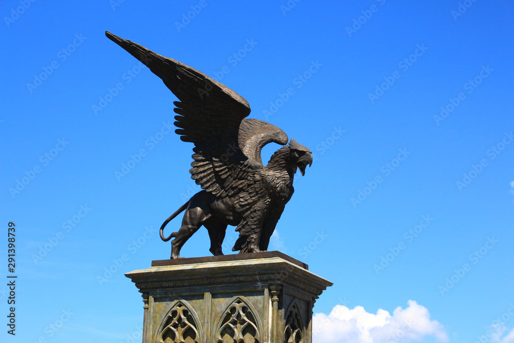Statue of Griffin or Griffon against the sky. A legendary creature with ...