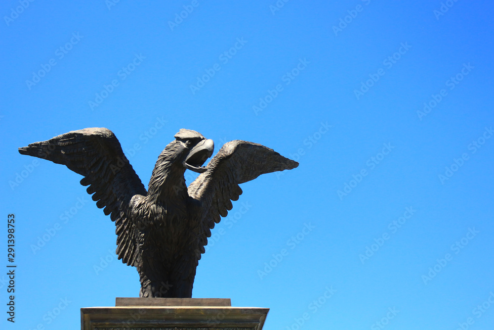 Statue of Griffin or Griffon against the sky. A legendary creature with ...