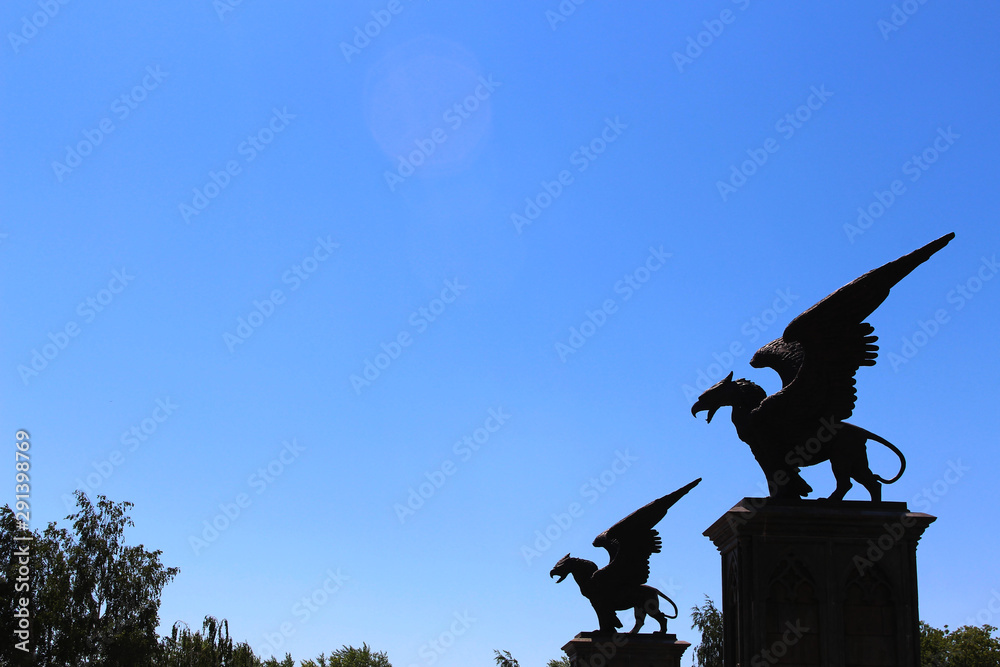Statues of Griffin or Griffon against the sky. A legendary creature ...