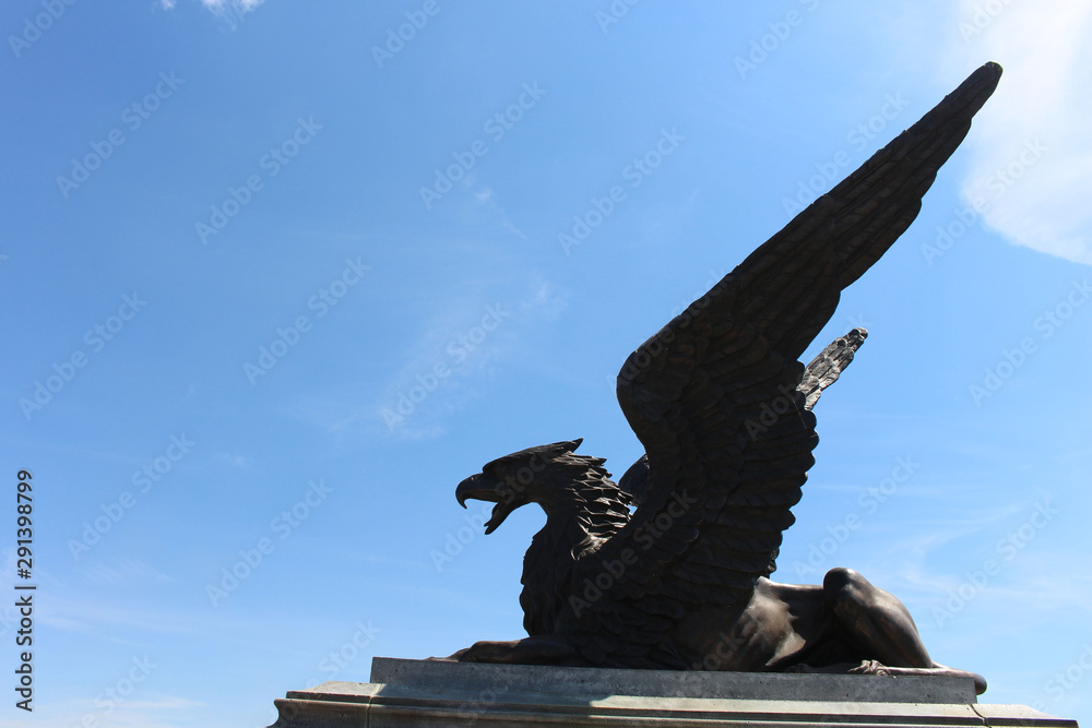 Statue of Griffin or Griffon against the sky. A legendary creature with ...