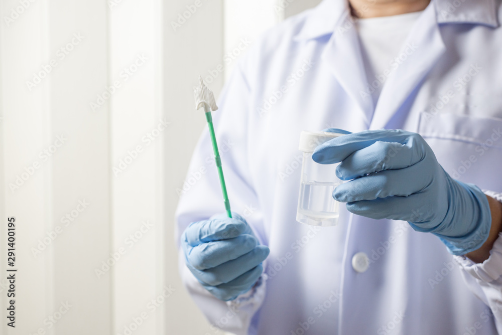 Doctor hand holding liquid base cytology set on blue background ...