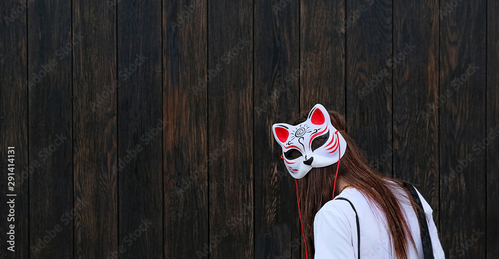 girl in Cat-man mask against wooden board wall. Japanese anime style ...