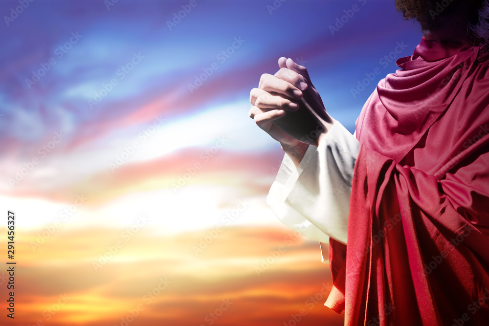 Jesus Christ raised hands and praying to god Stock Photo | Adobe Stock