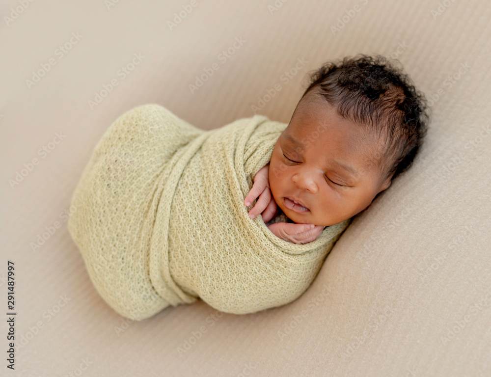 Sleeping baby swaddled in sheet Stock Photo | Adobe Stock