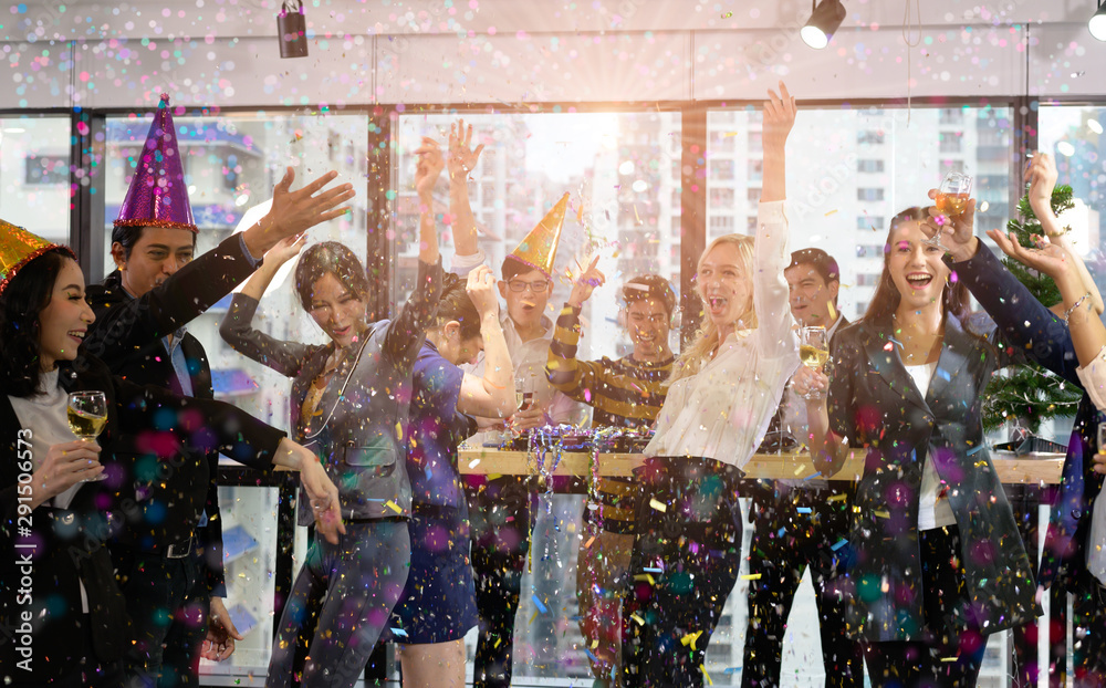 Group of office workers celebrating winter holidays together at work ...