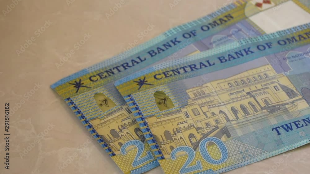 20 Riyal bills of cash, the currency of the Oman notes spread out on a ...