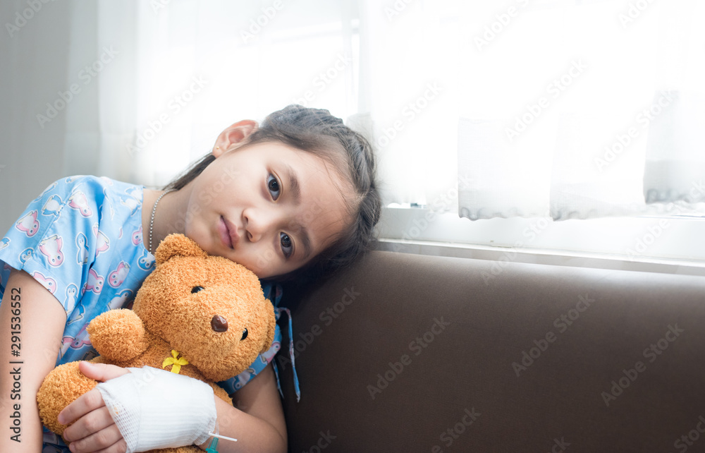 Patient girl feeling sad,illness.She hug her bear & sitting on Hospital ...