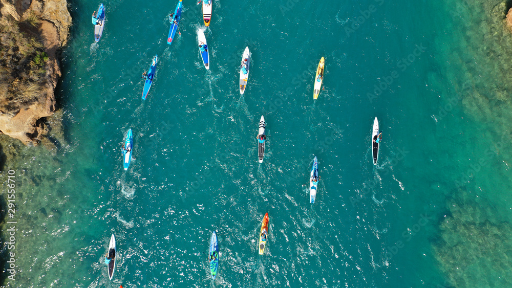 Aerial bird's eye view photo taken by drone of stand up paddle surfers ...