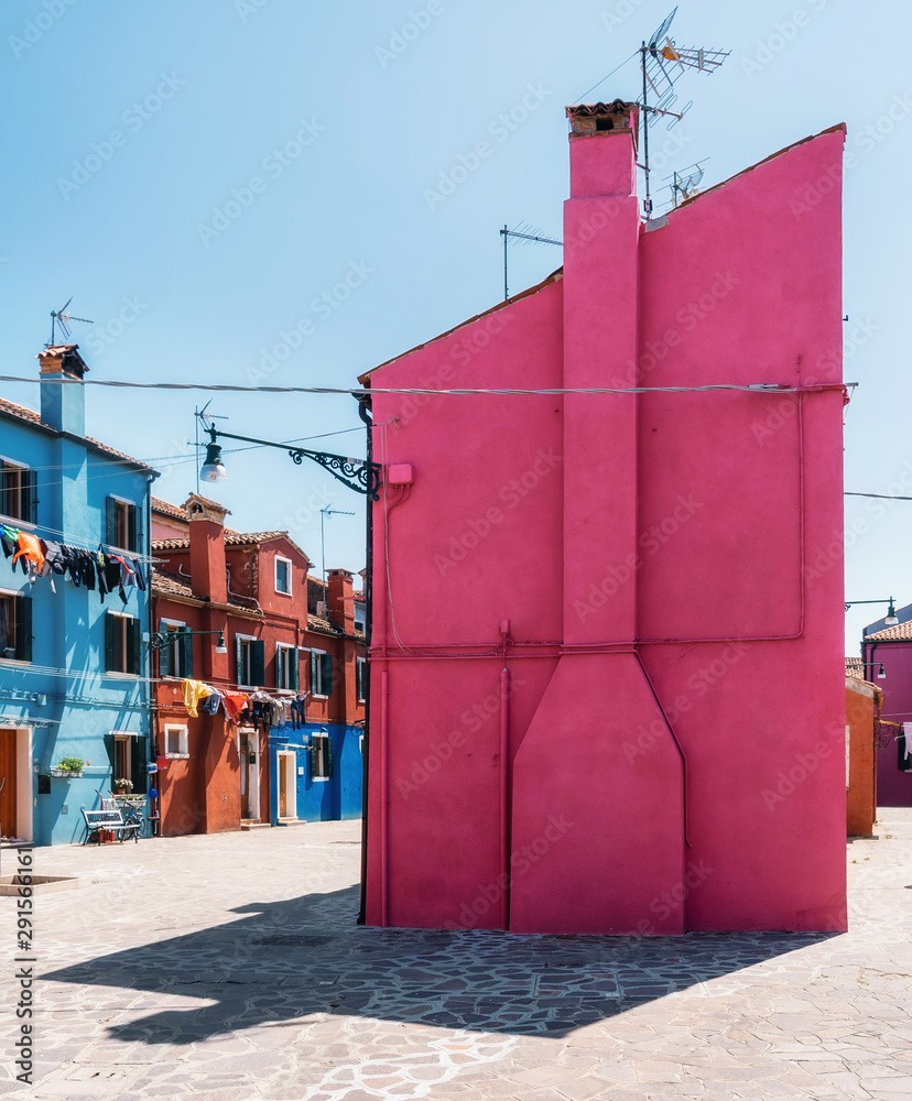 View of vivid pink stone house with chimney. Minimalism and free space ...
