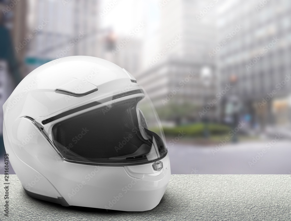 White motorcycle helmet on city baground Stock Photo | Adobe Stock