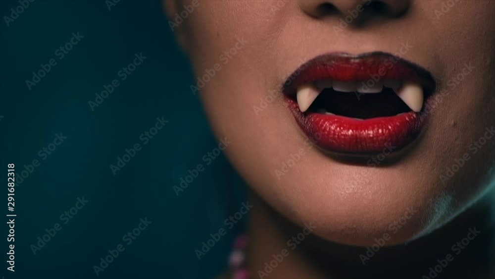 Sexy Vampire Woman's red bloody lips close-up. Vampire girl licking ...