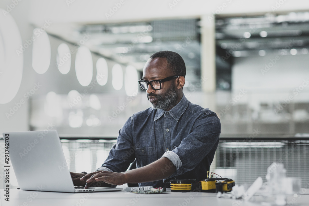African American adult male working on robotics Stock Photo | Adobe Stock