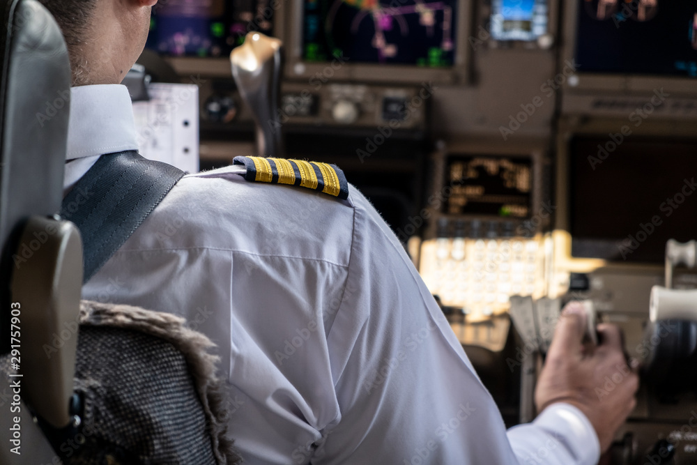 Airliner captain controlling airplane in cockpit. He pulling spreed ...