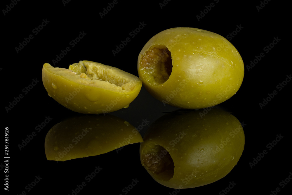 Group of one whole one half of pitted green olive isolated on black ...
