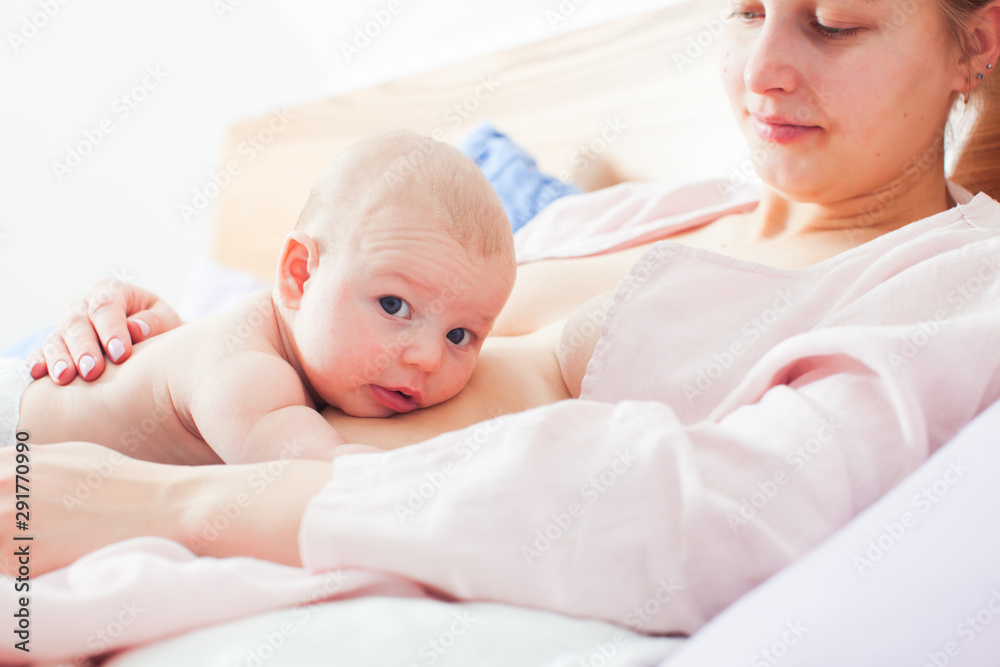 Newborn and mother in relaxed laid back breastfeeding pose Stock Photo ...