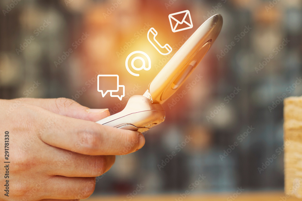 closeup hand using classic ancient clapet phone with icon mobile phone ...