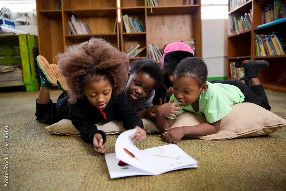 School kids reading in the classroom Stock Photo | Adobe Stock