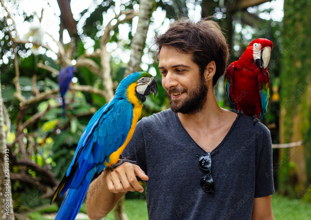 Young man in the bird park Stock Photo | Adobe Stock