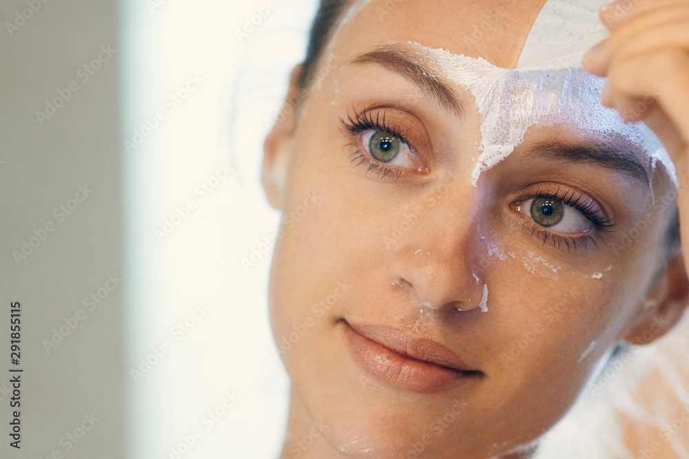 Content woman removing purifying mask Stock Photo | Adobe Stock