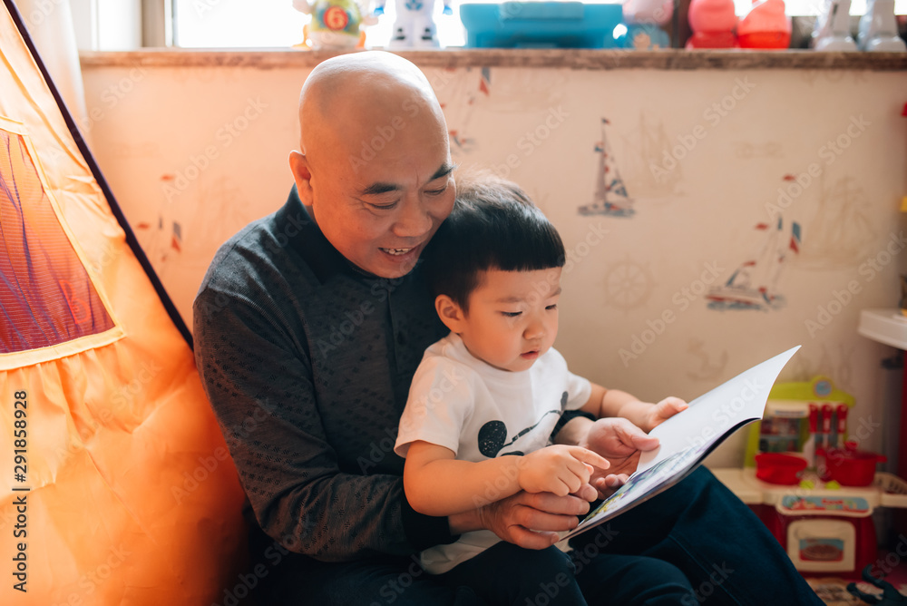Grandpa reading books with grandson Stock Photo | Adobe Stock