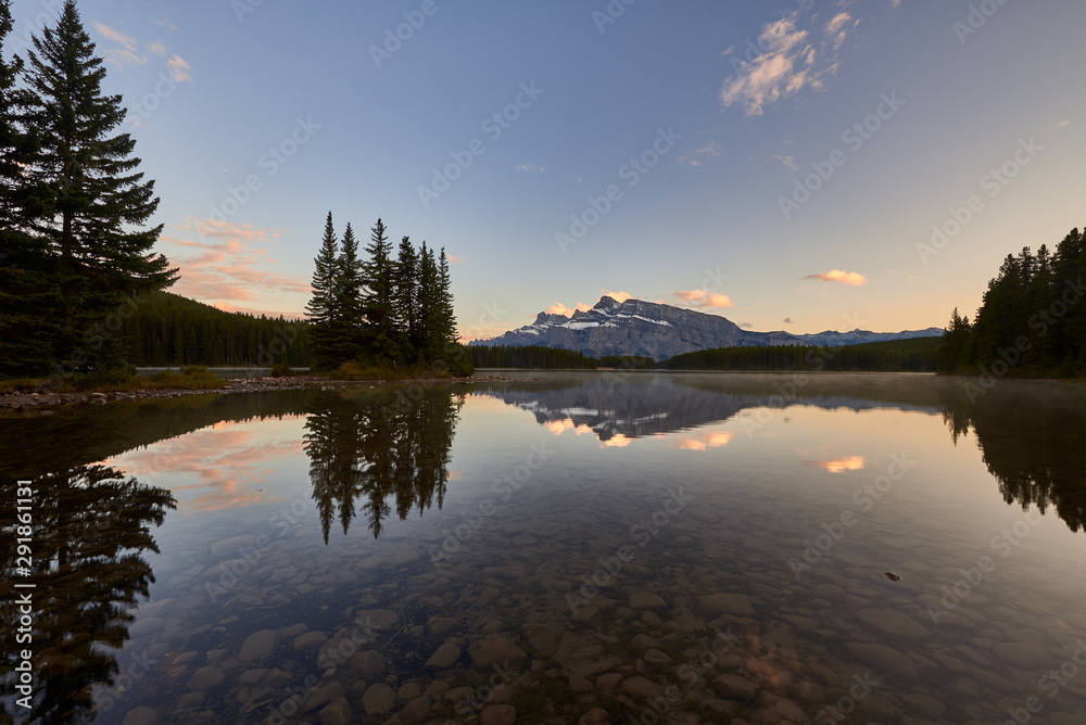 Rundle Mountain reflecting in Two Jack Lake in Banff National Park at ...