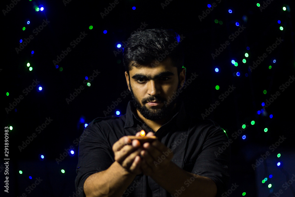 Foto de Young handsome guy with diwali diya(oil lamp). Diwali is ...