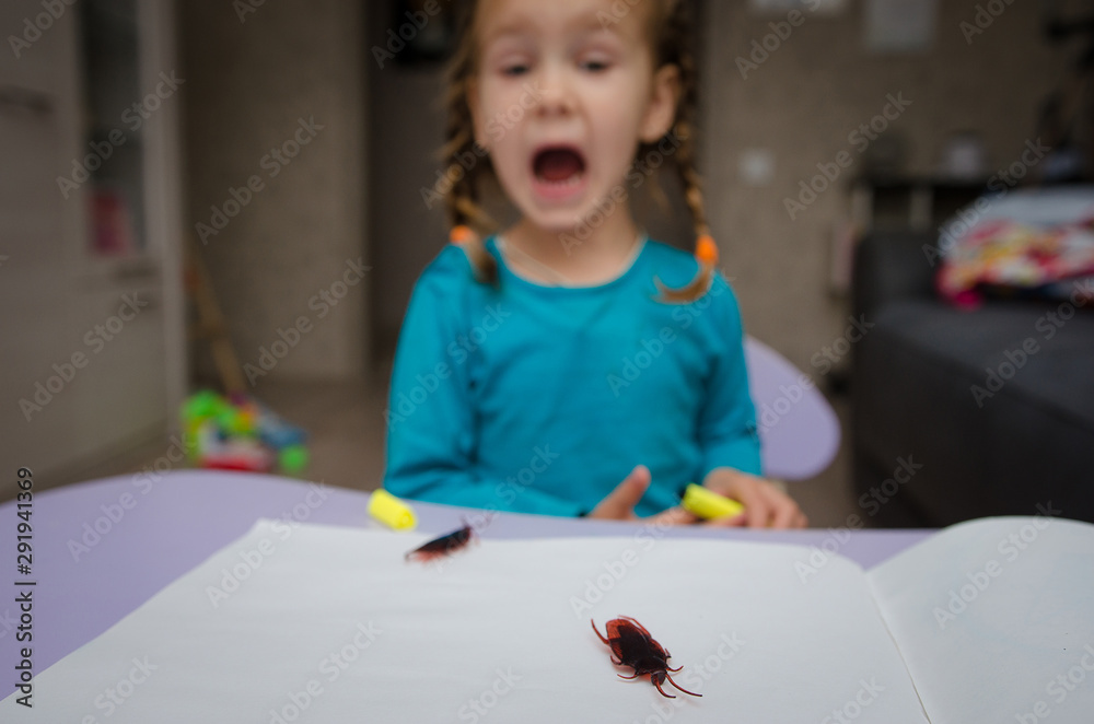 The cute little girl looking and afraid of cockroaches, Because the ...