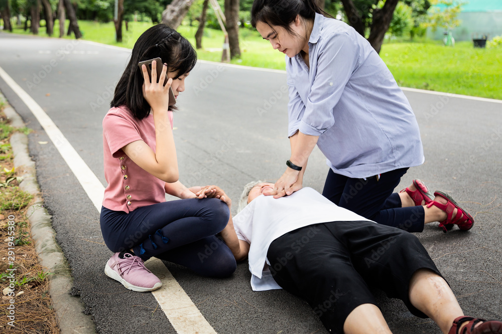 Asian mother first aid emergency CPR on unconscious senior grandmother ...
